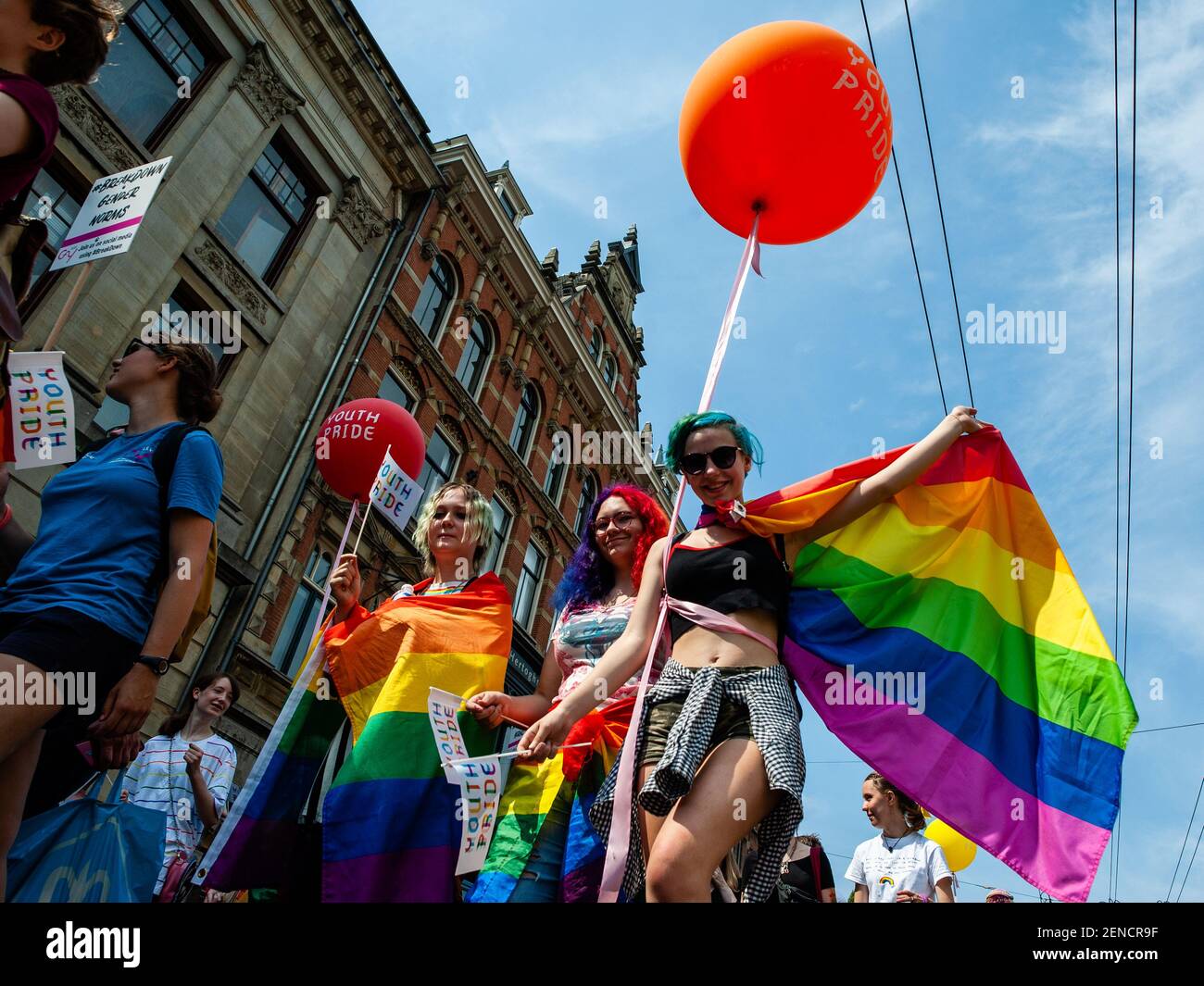 A woman uses a rainbow flag as a cloak during the Pride Walk. Because ...