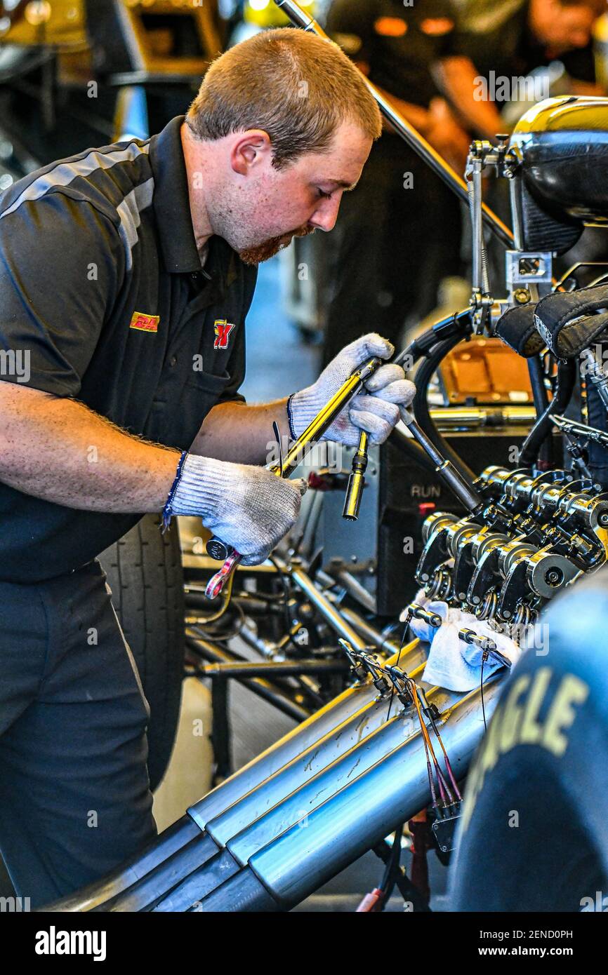 July 28, 2019: A mechanic works on the heads of a top fuel dragster ...