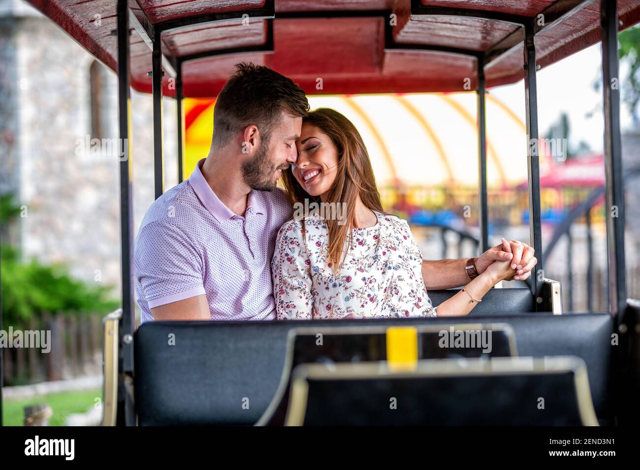 Sweet couple on a love train enjoying themselves Stock Photo - Alamy