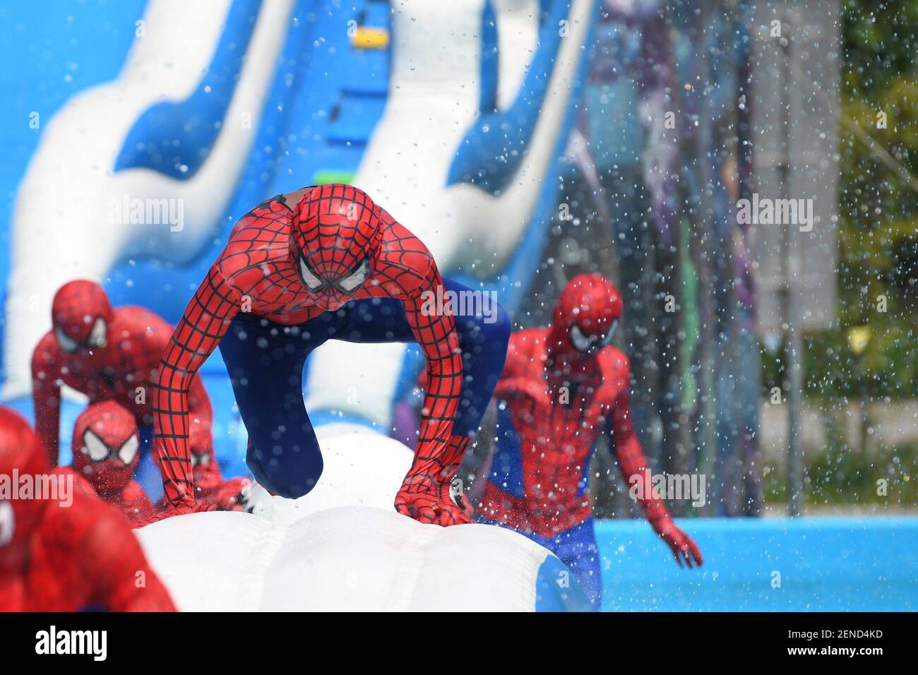 Chinese staff memers dressed as Spider-Man play in a swimming pool ...
