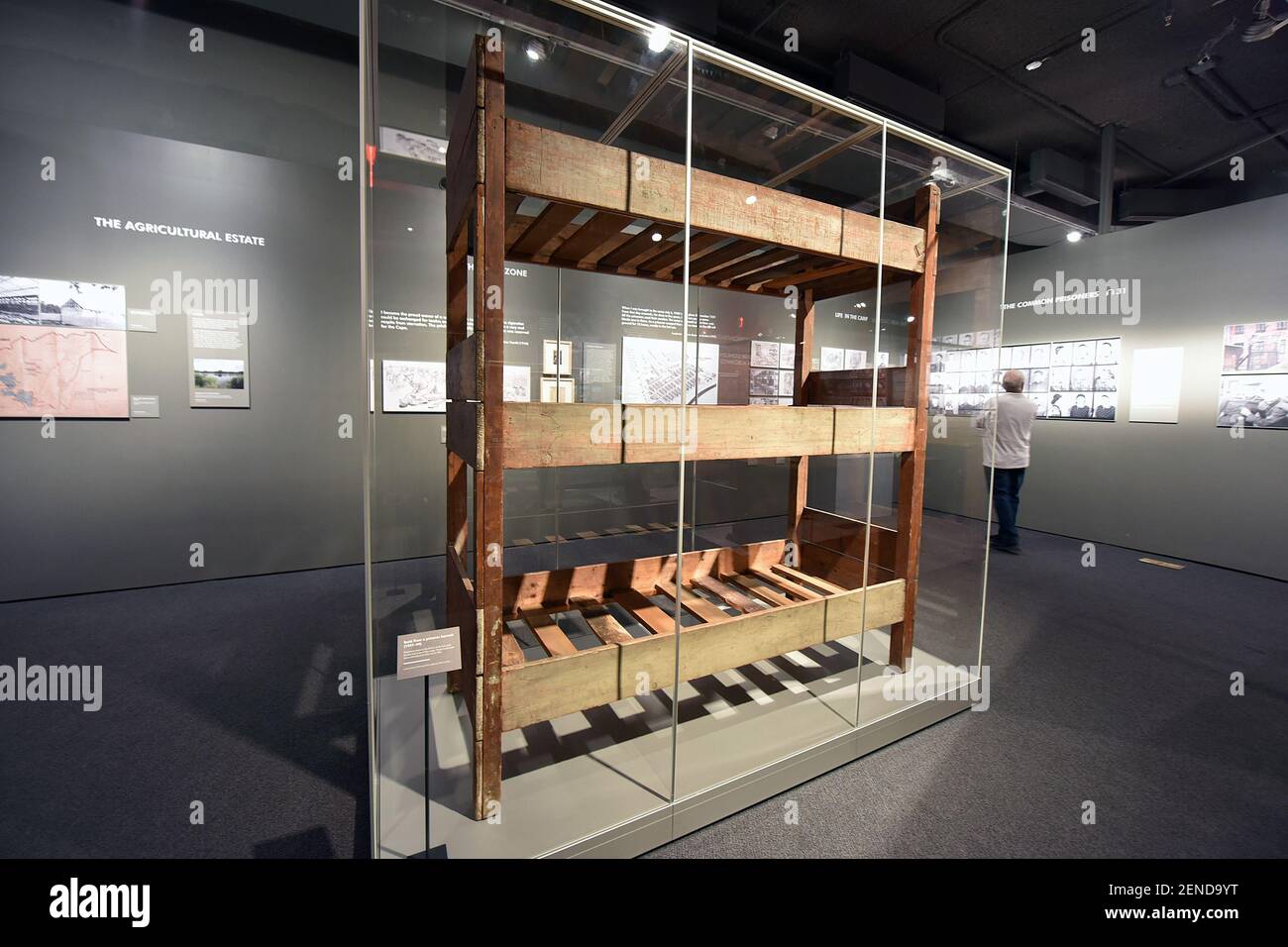 Three-tier bunk bed for prisoners on display as part of the “Auschwitz ...