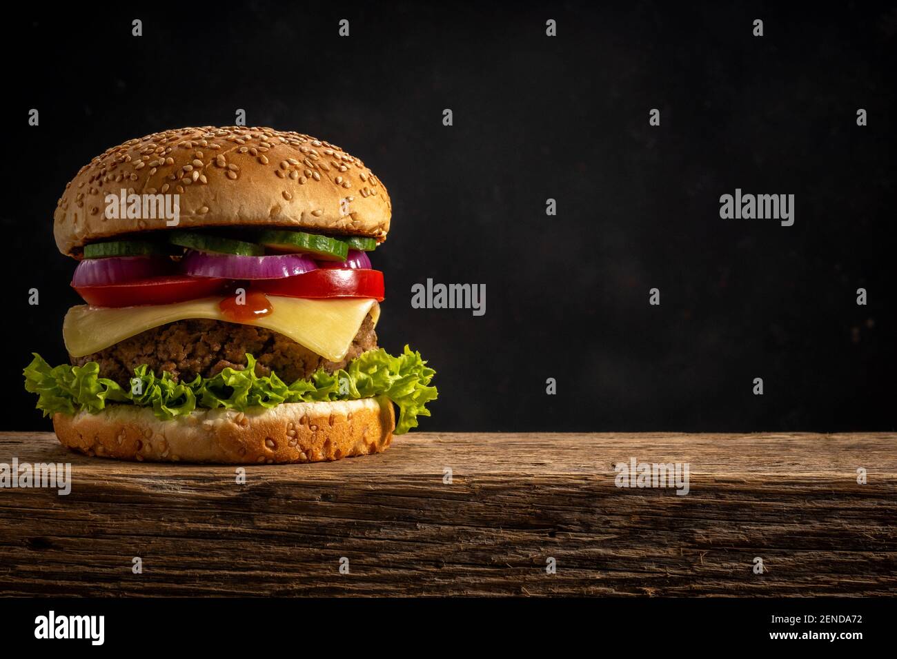 View of fresh tasty burger on wooden rustic table. Food background ...