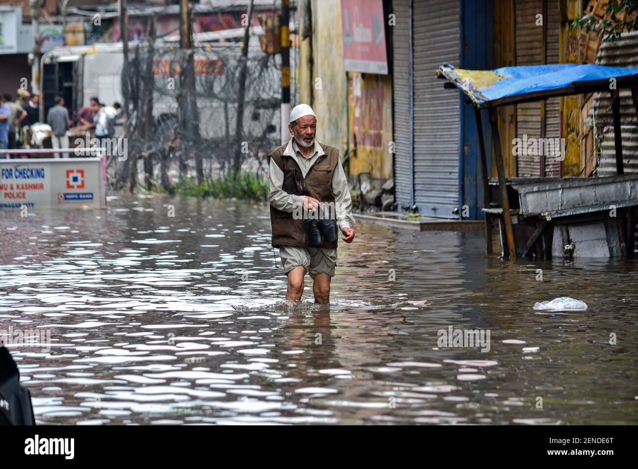 An elderly man waded after the heavy rains in Srinagar. Rains caused ...