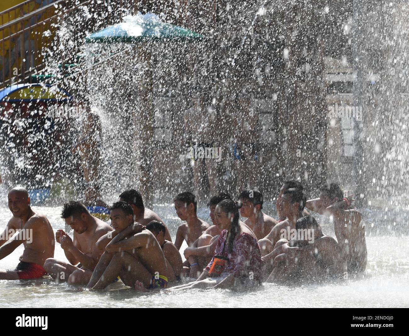 Chinese holidaymakers crowd a swimming pool at a water park to escape ...