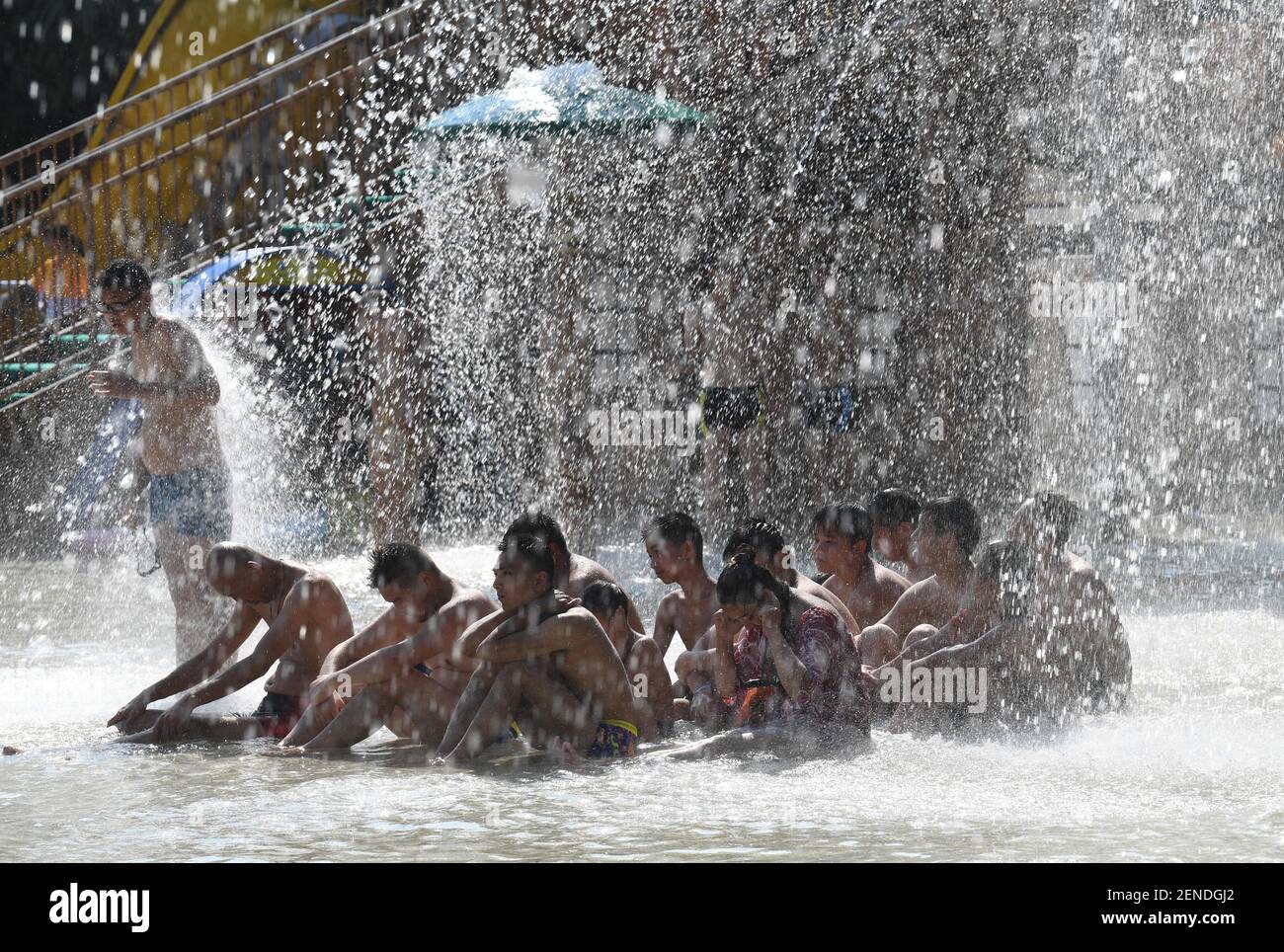 Chinese holidaymakers crowd a swimming pool at a water park to escape ...
