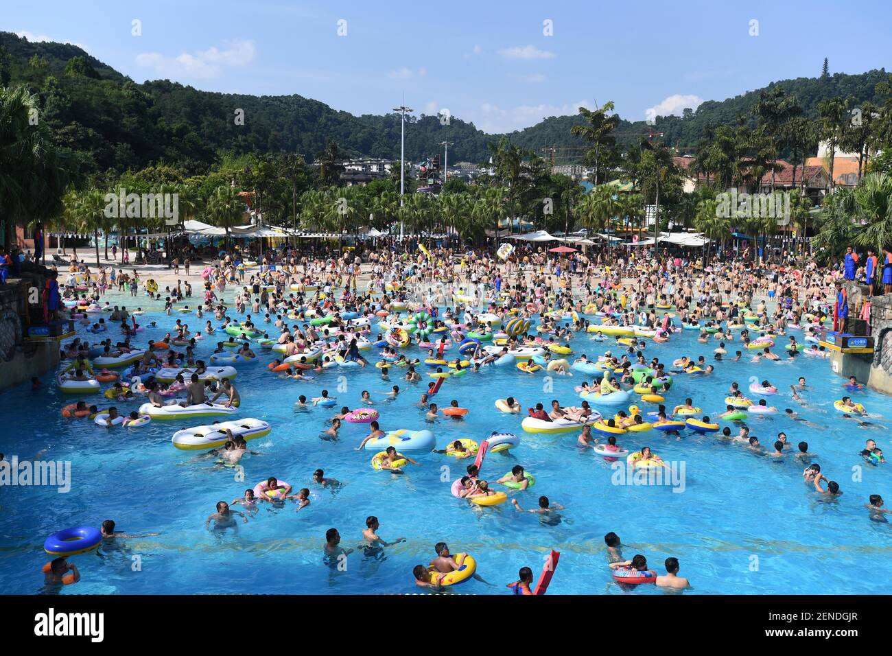 Chinese holidaymakers crowd a swimming pool at a water park to escape ...
