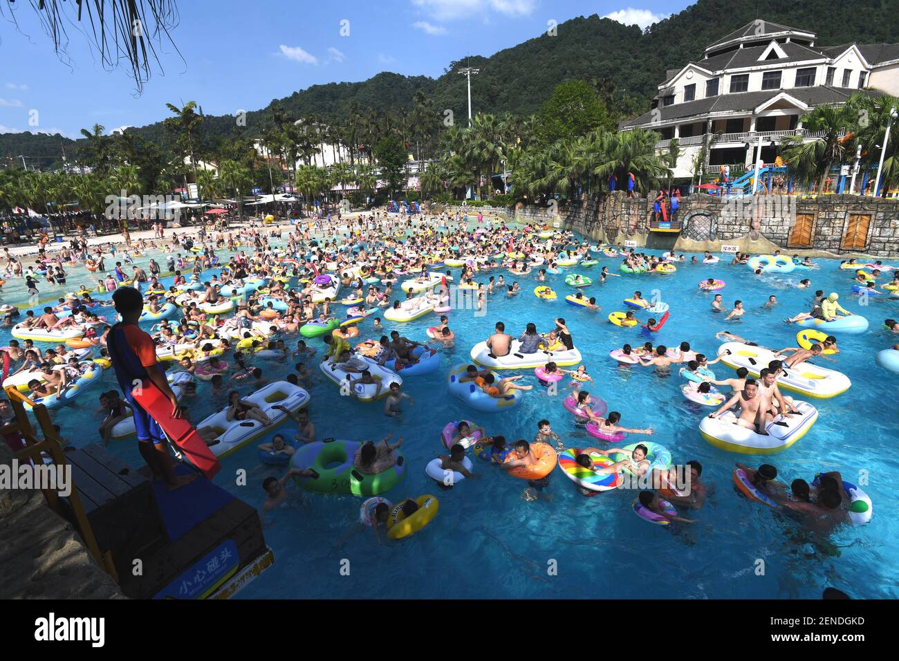 Chinese holidaymakers crowd a swimming pool at a water park to escape ...