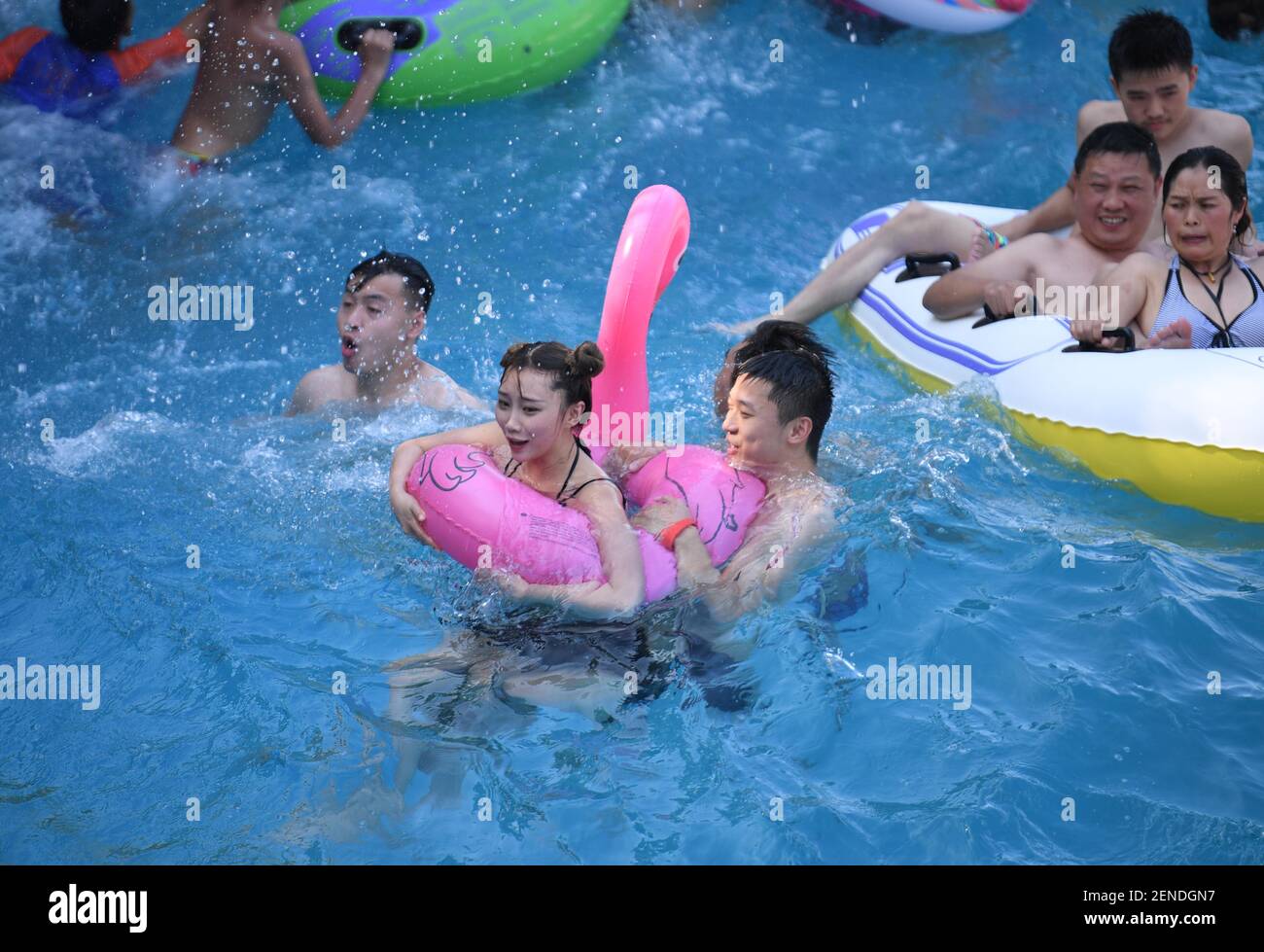 Chinese holidaymakers crowd a swimming pool at a water park to escape ...
