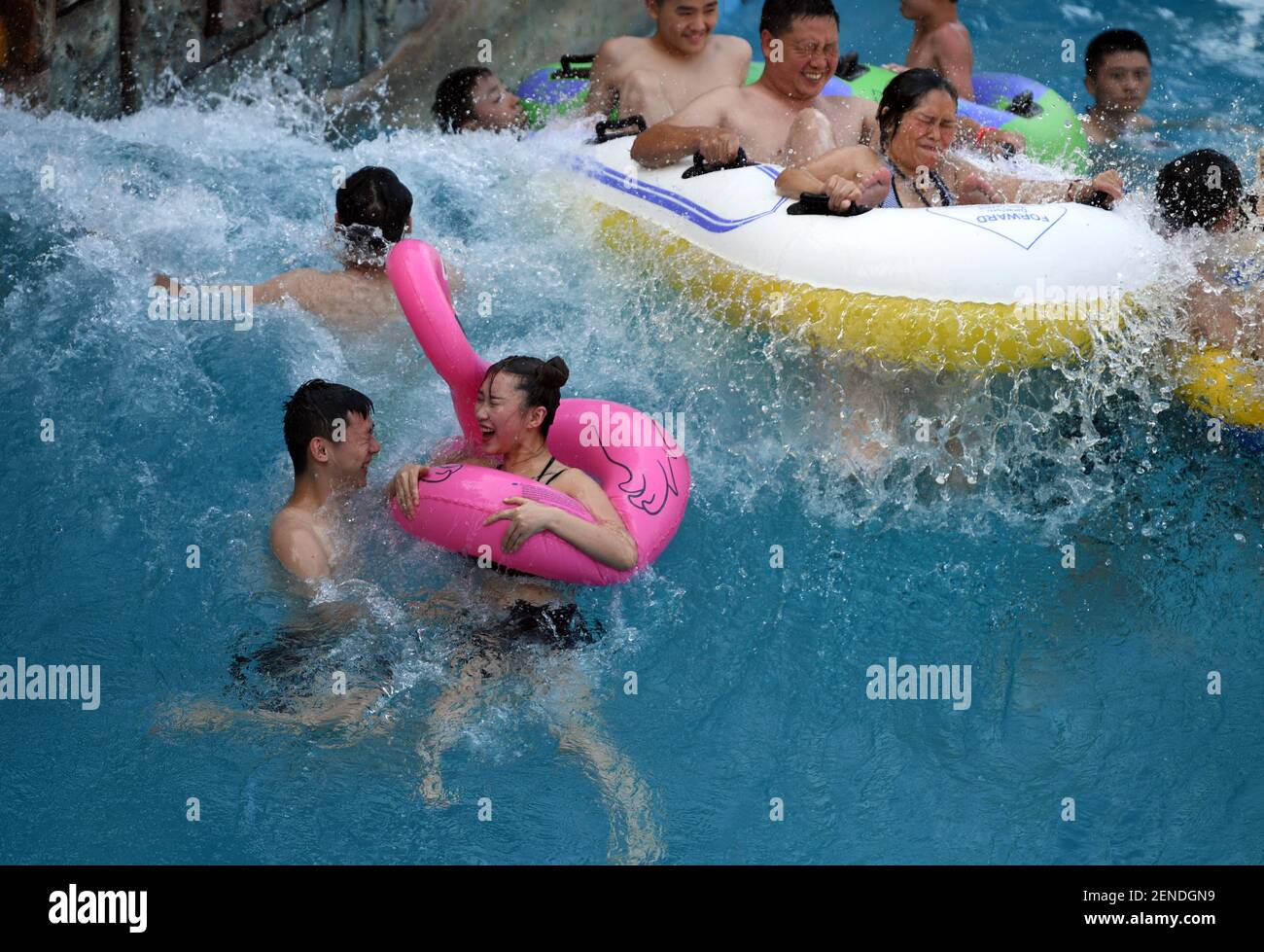 Chinese holidaymakers crowd a swimming pool at a water park to escape ...