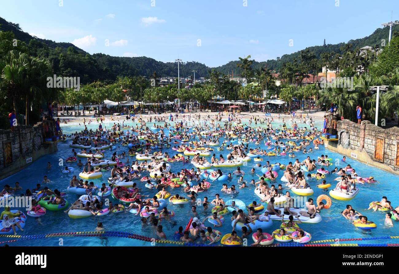 Chinese holidaymakers crowd a swimming pool at a water park to escape ...