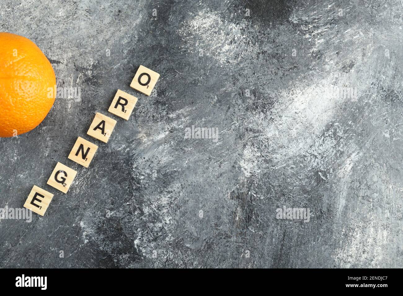 Whole orange with wooden letters spelled as orange Stock Photo - Alamy