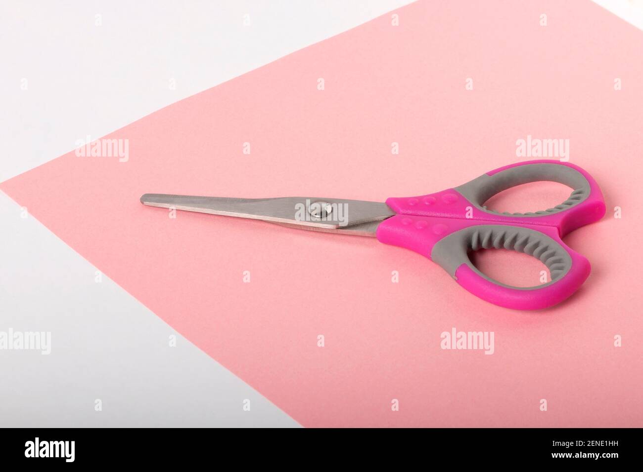 Pink scissors for cutting sheets of paper and fabric. For office and ...