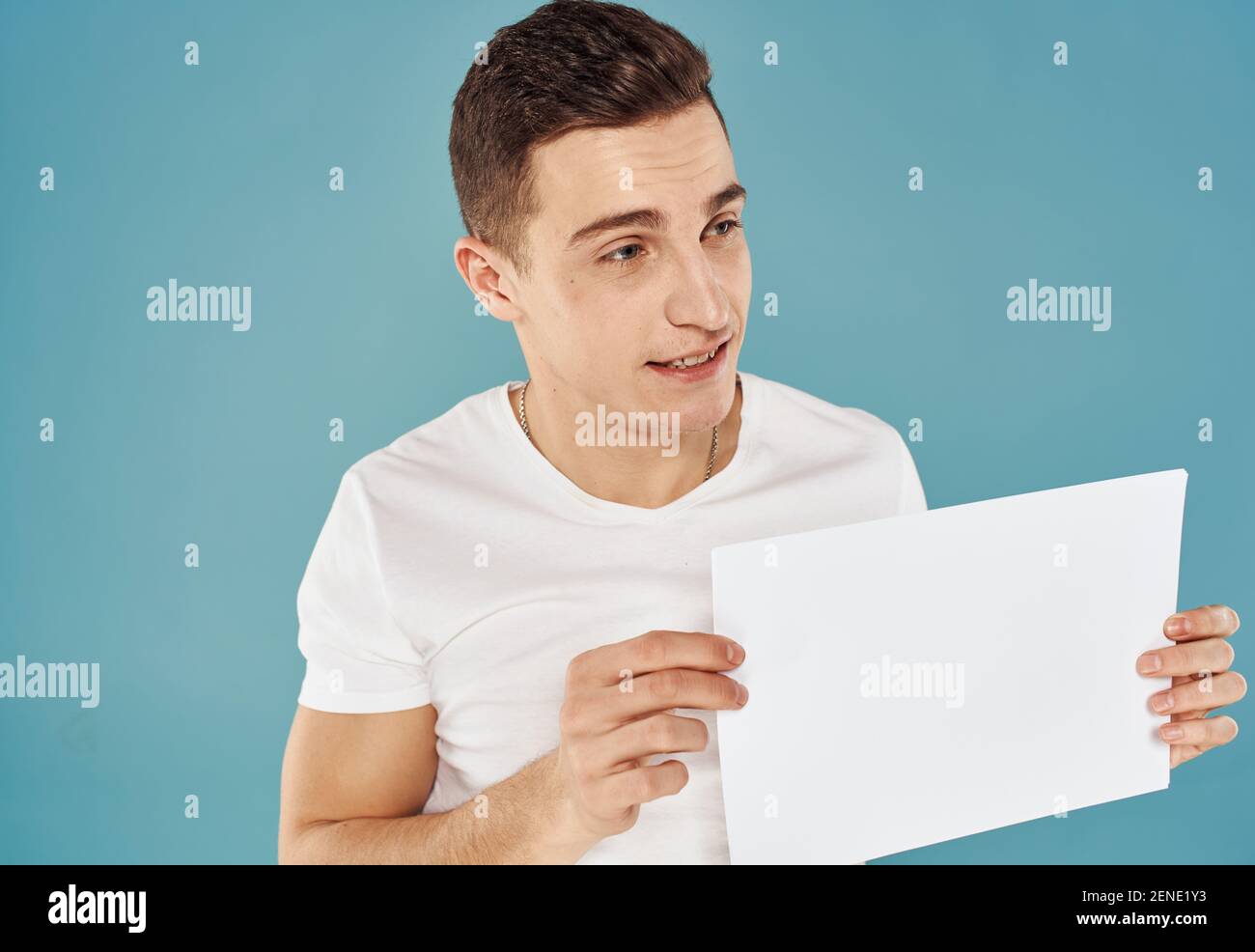 man with flyer in hand and mockup blue background cropped view Stock ...