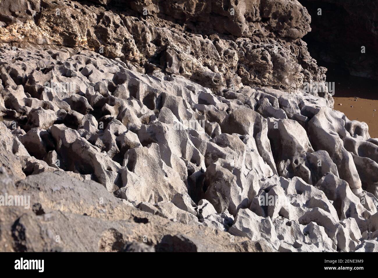 Various shapes of rock on a popular beach at low tide, these rocks are ...