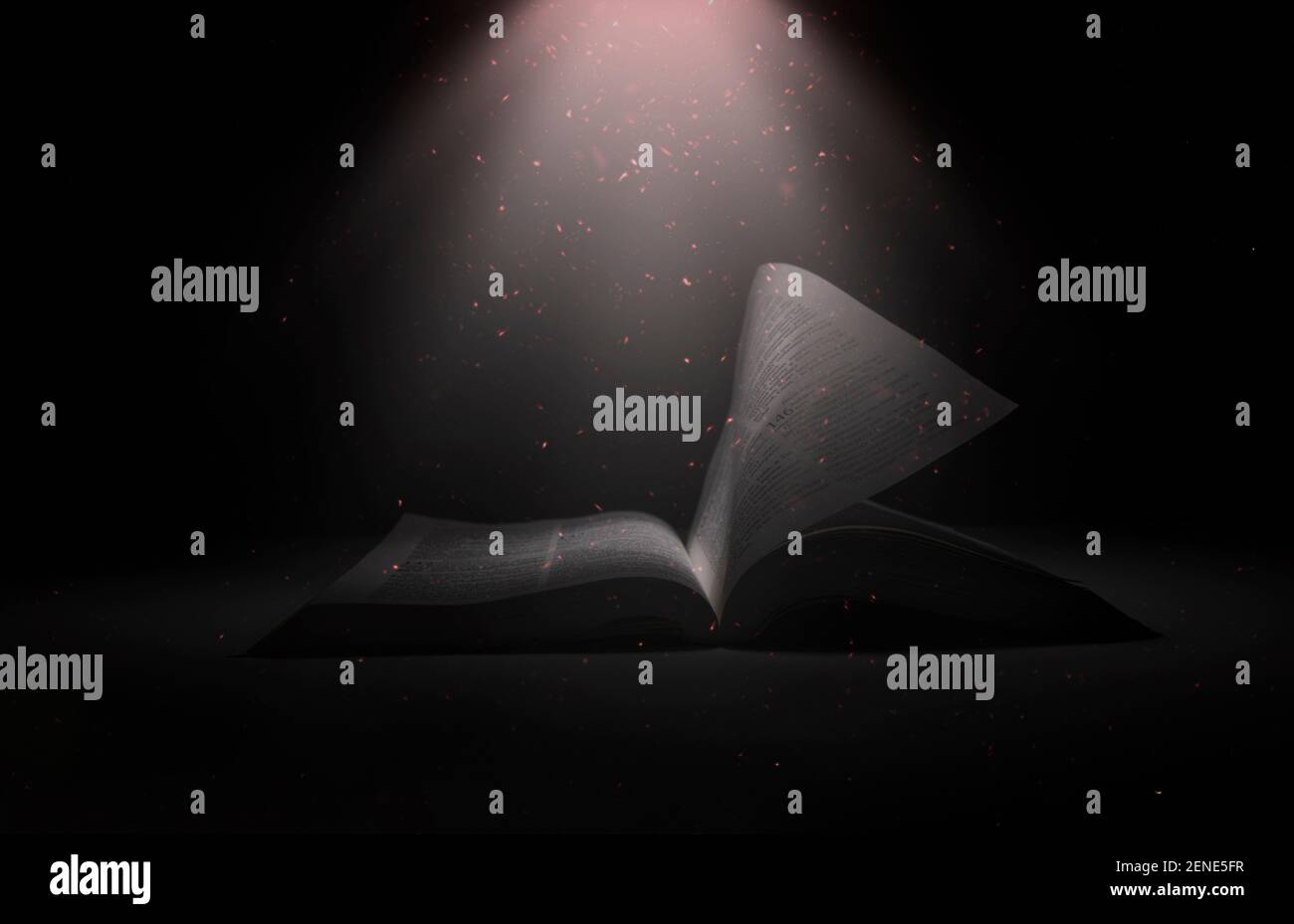 An open Bible on a table with light coming from above. A magic book ...