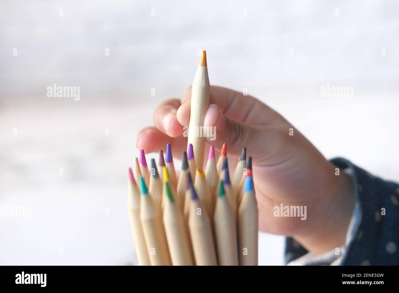 child girl picking a color drawing pencil from a box Stock Photo - Alamy