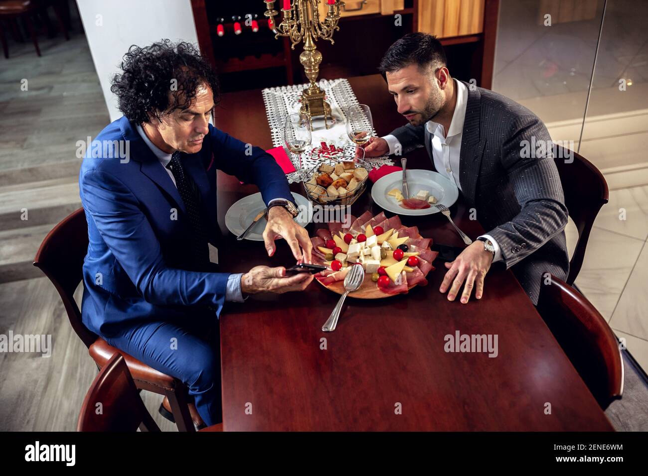 Two successful bosses having dinner, business and businessmen concept ...