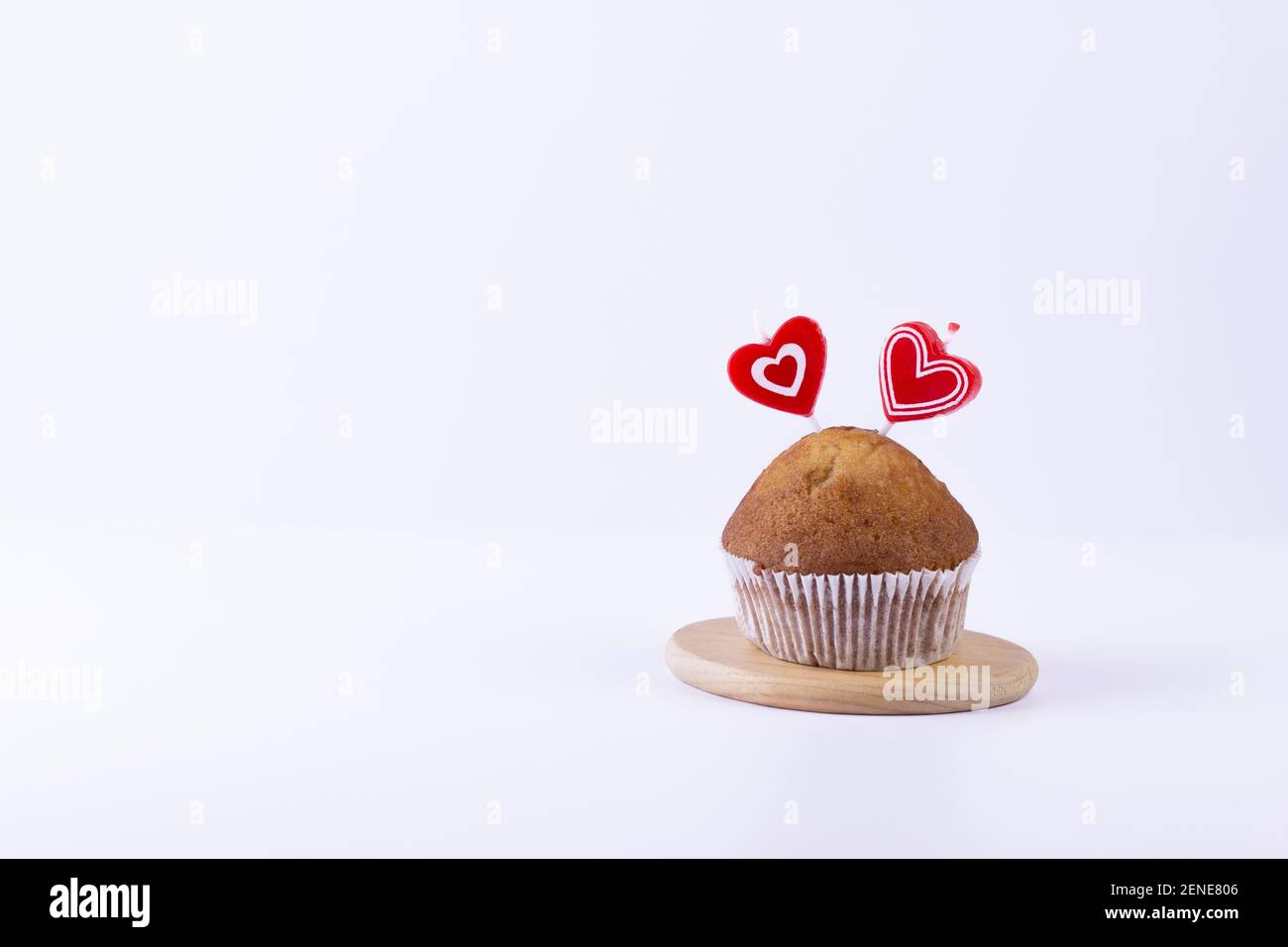 Homemade muffin with heart shape candles on white background. Holiday ...