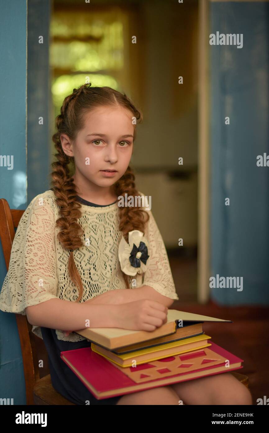 Back to school and education concept. Girl holds big open blue book ...