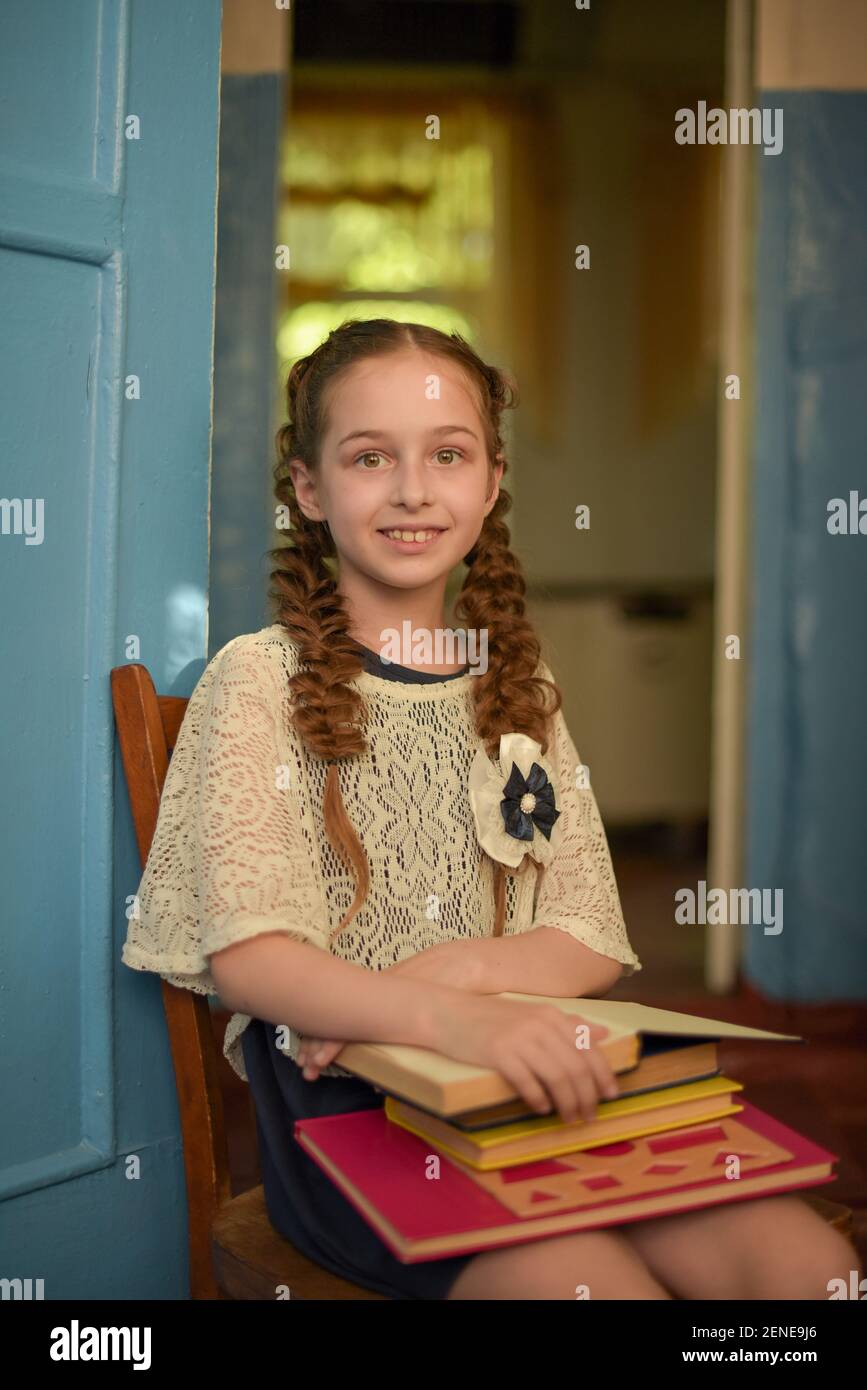 Back to school and education concept. Girl holds big open blue book ...