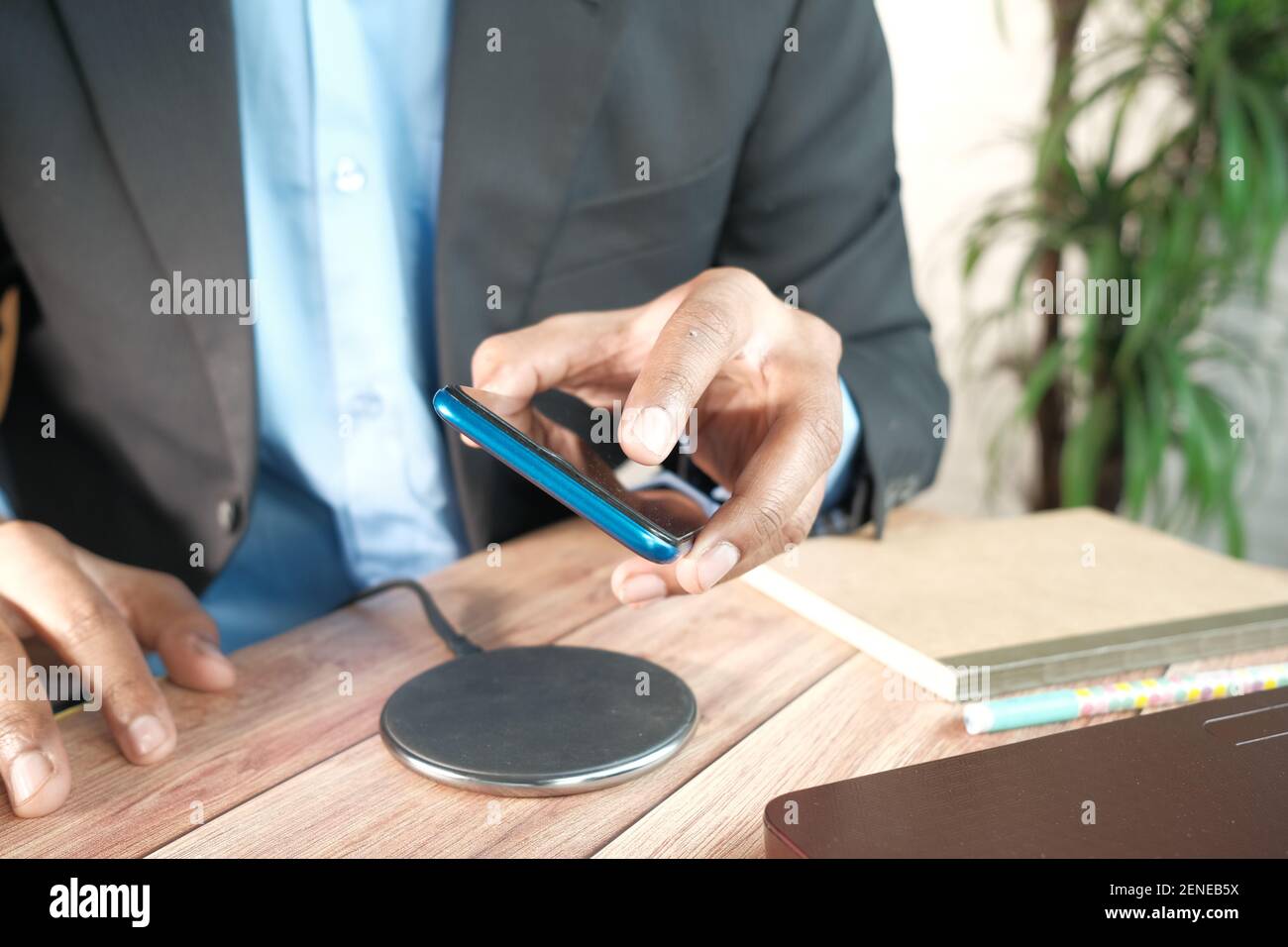 charging Smartphone using Wireless Charging Pad, top view Stock Photo ...