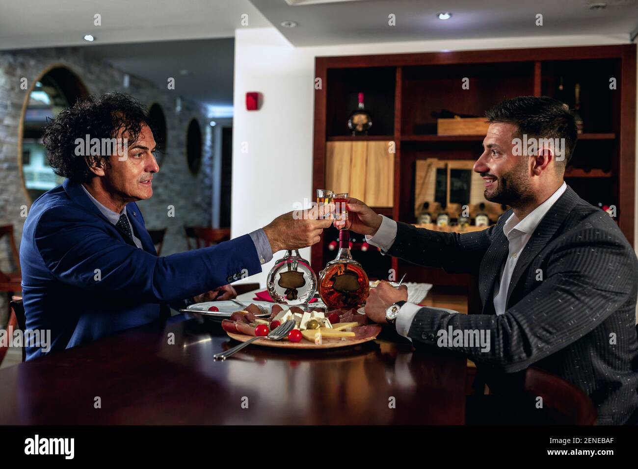 Two businessmen relaxing toasting hi-res stock photography and images ...