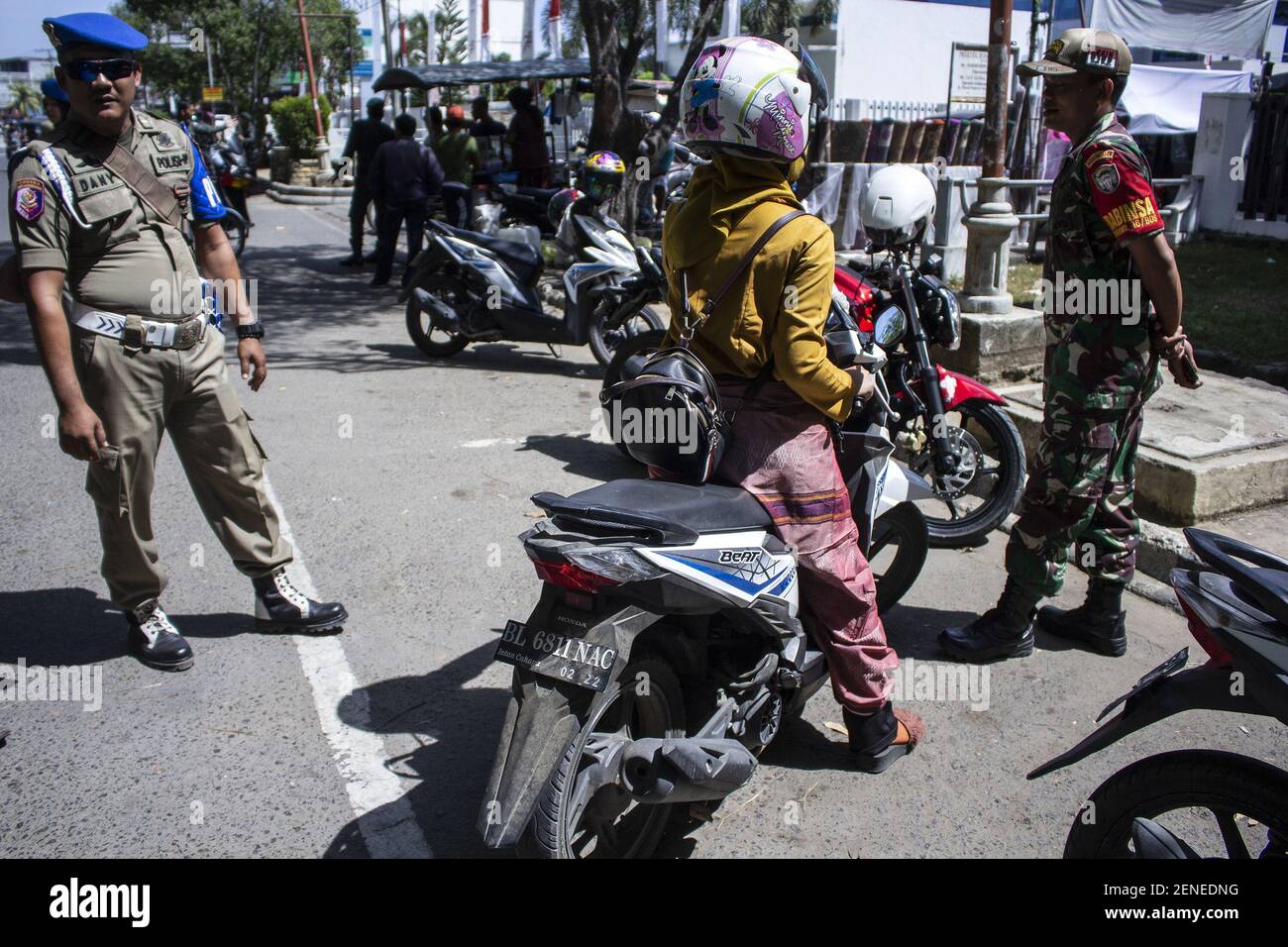 A motorcyclist wearing a sarong during the enforcement. Dozens of ...