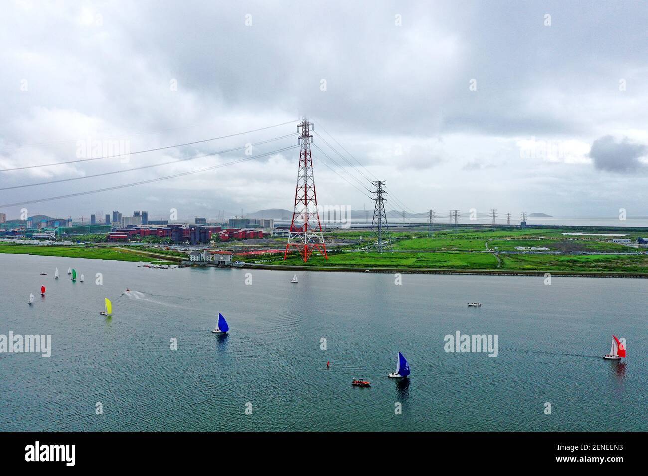 Sailboats compete against each other despite the cloudy weather in ...