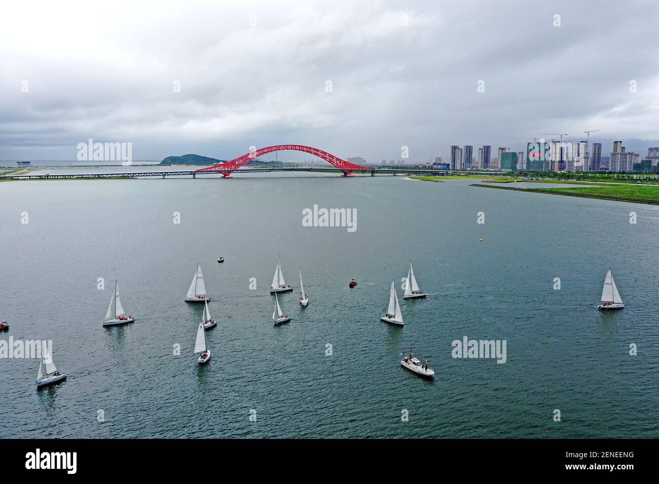 Sailboats compete against each other despite the cloudy weather in ...