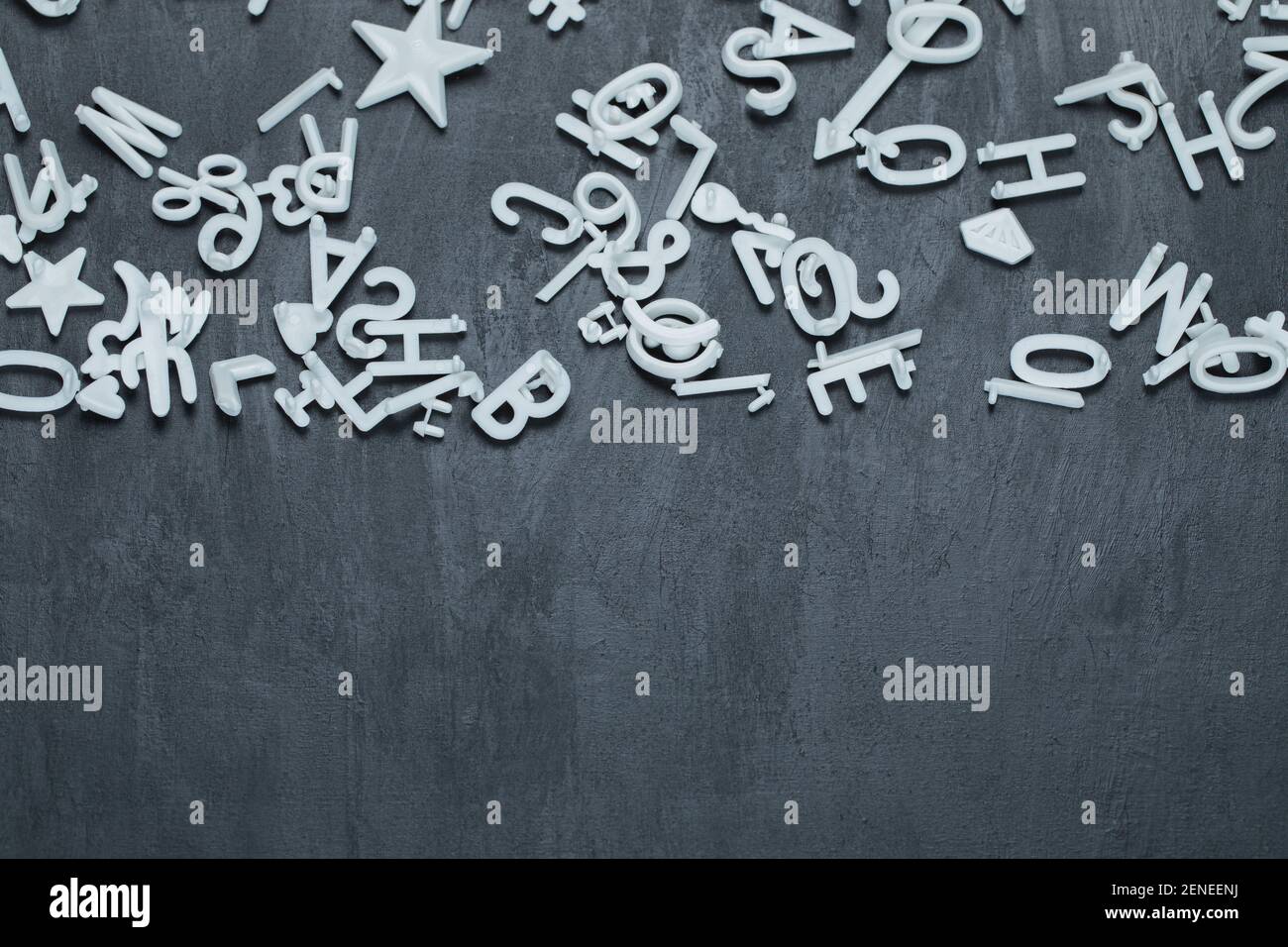 White plastic letters and icons on black background Stock Photo - Alamy