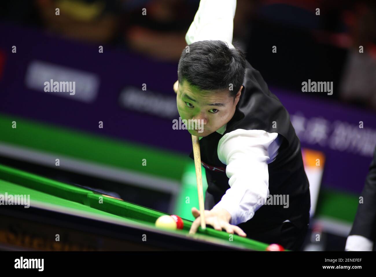 Ding Junhui of China plays a shot to Zhao Xintong of China in the first ...
