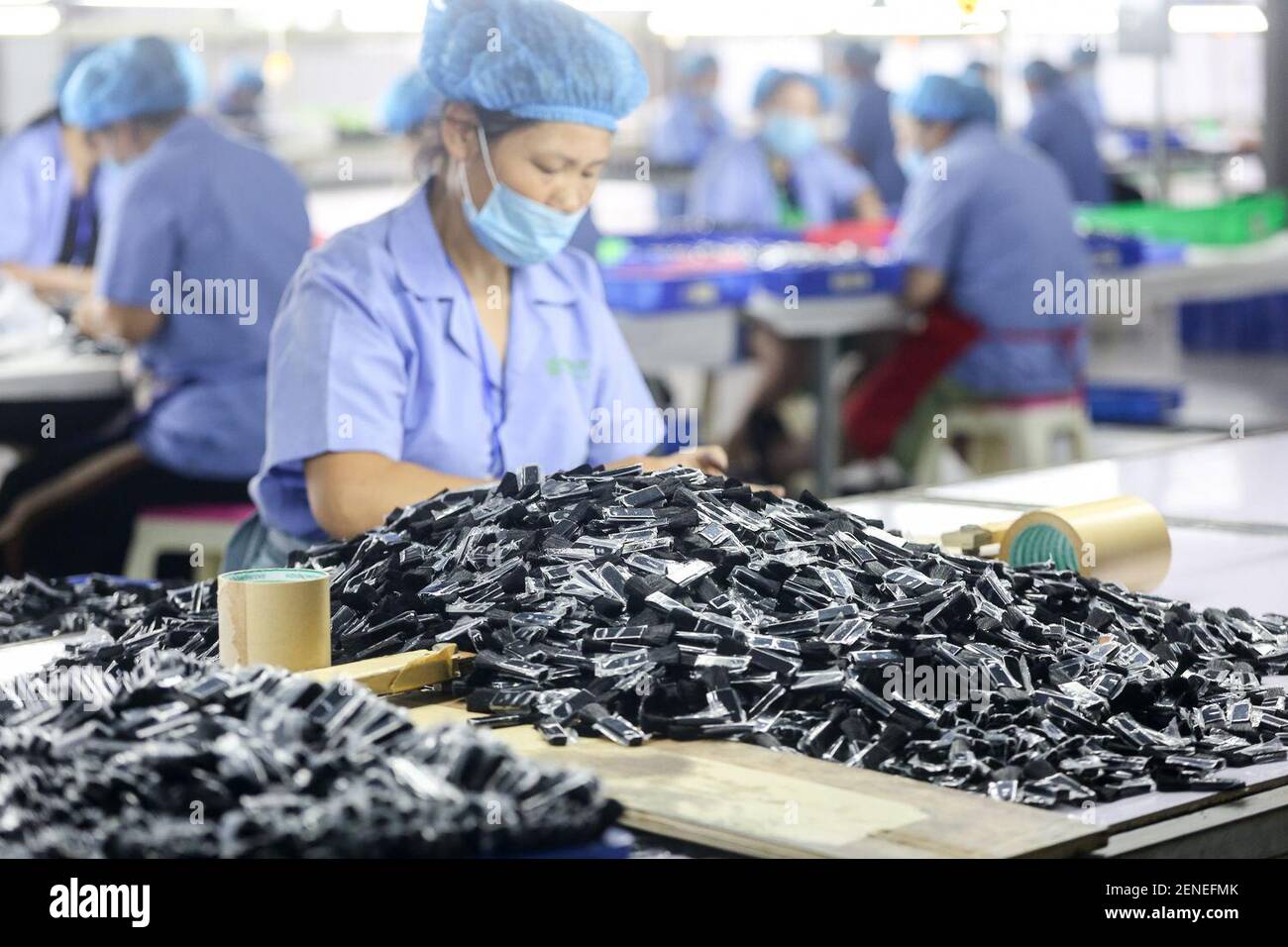 Chinese female workers manufacture makeup brushes on an assembly line ...