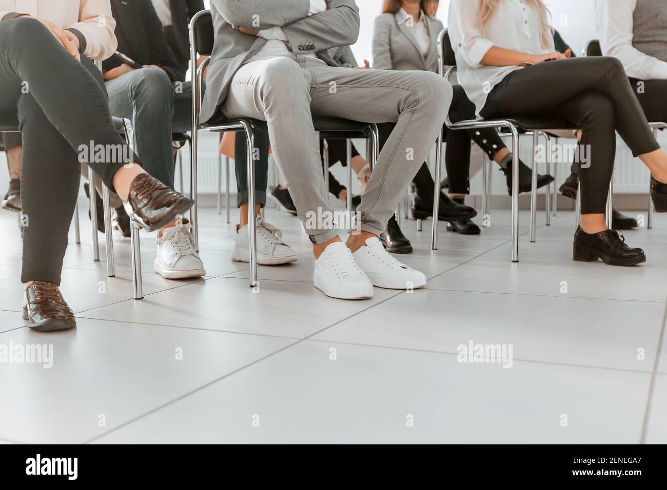 background image of a group of employees sitting in a conference room ...
