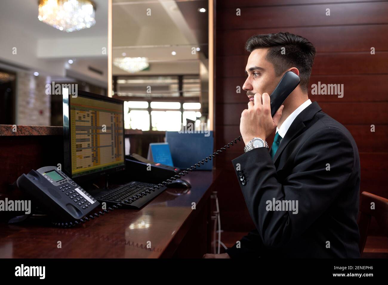 Receptionist sitting behind reception desk hi-res stock photography and images - Alamy