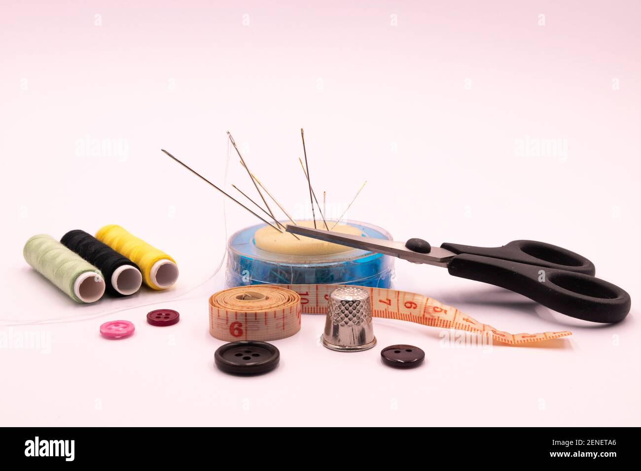 photography of different colored sewing threads and sewing tools on ...