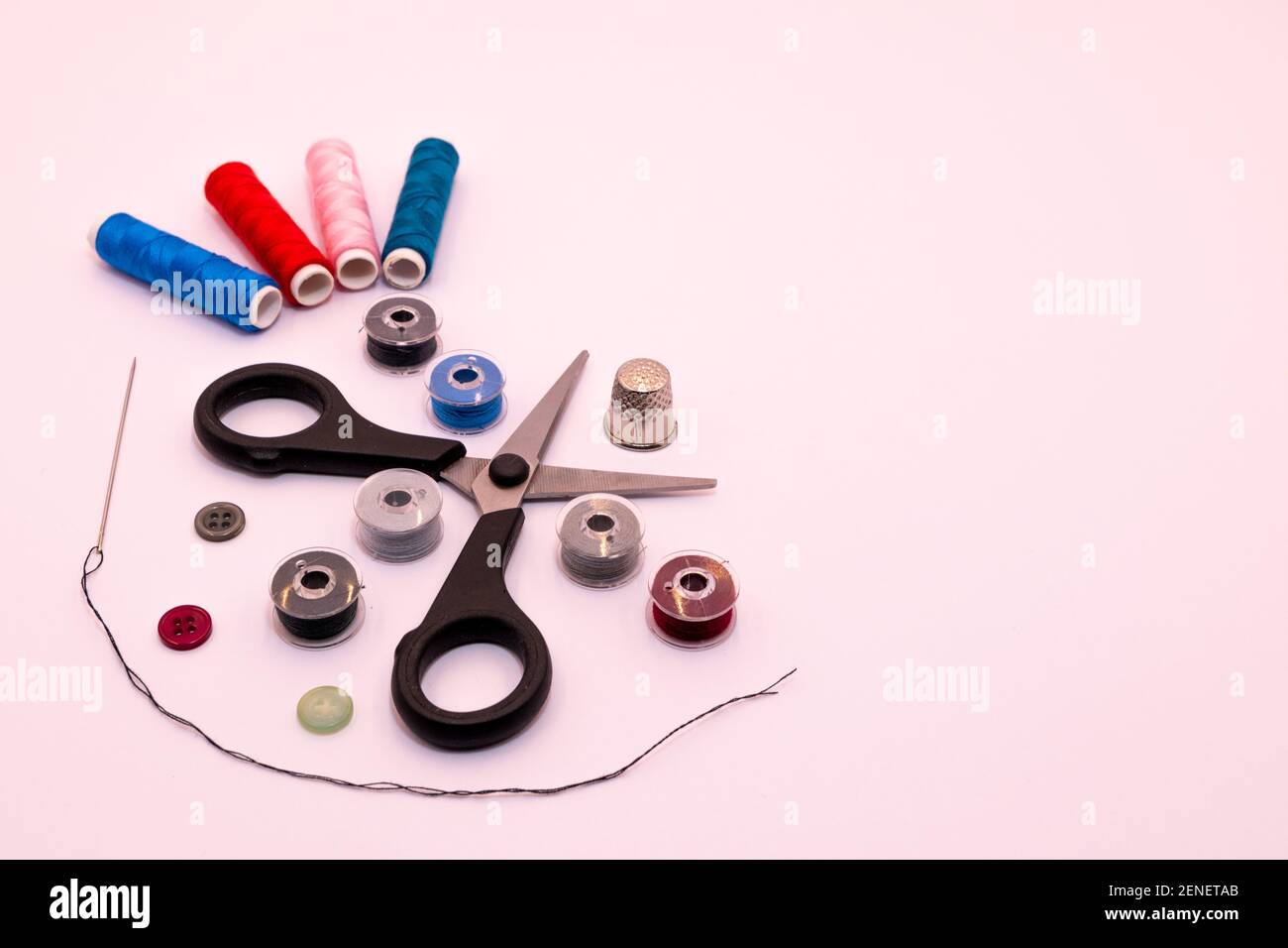 photography of sewing threads and sewing tools on white background ...