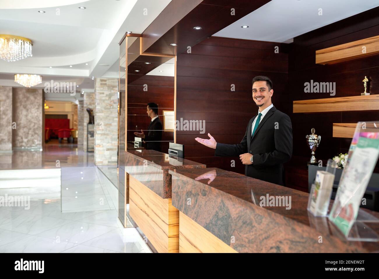 Receptionist welcoming guests to a hotel, concept of tourism Stock ...