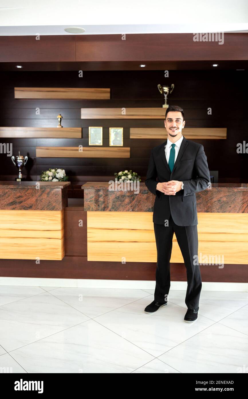 Hotel worker welcoming guests hi-res stock photography and images - Alamy