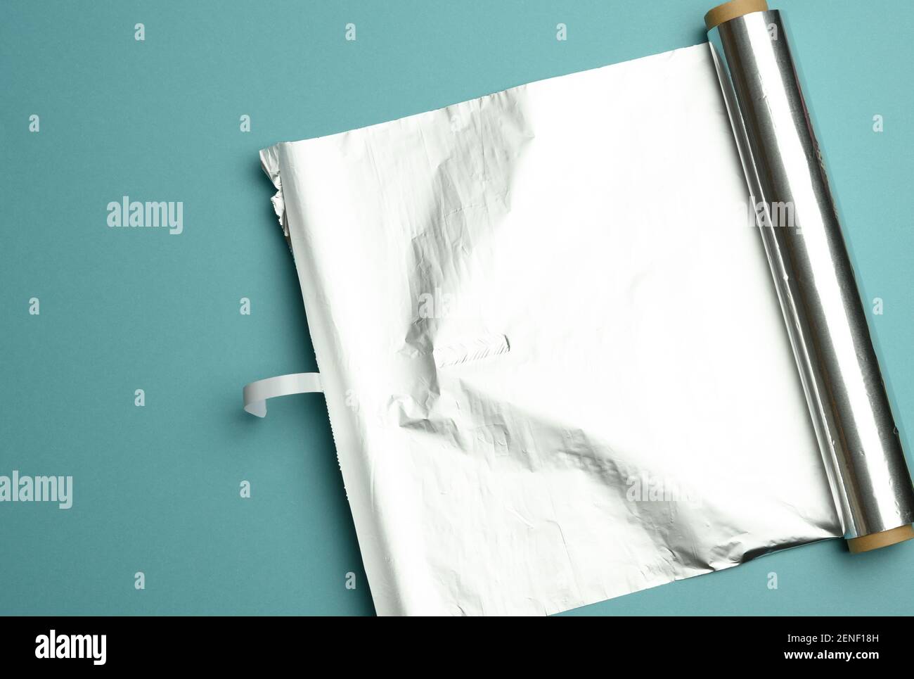 unwrapped roll of gray foil on a blue background, top view Stock Photo ...