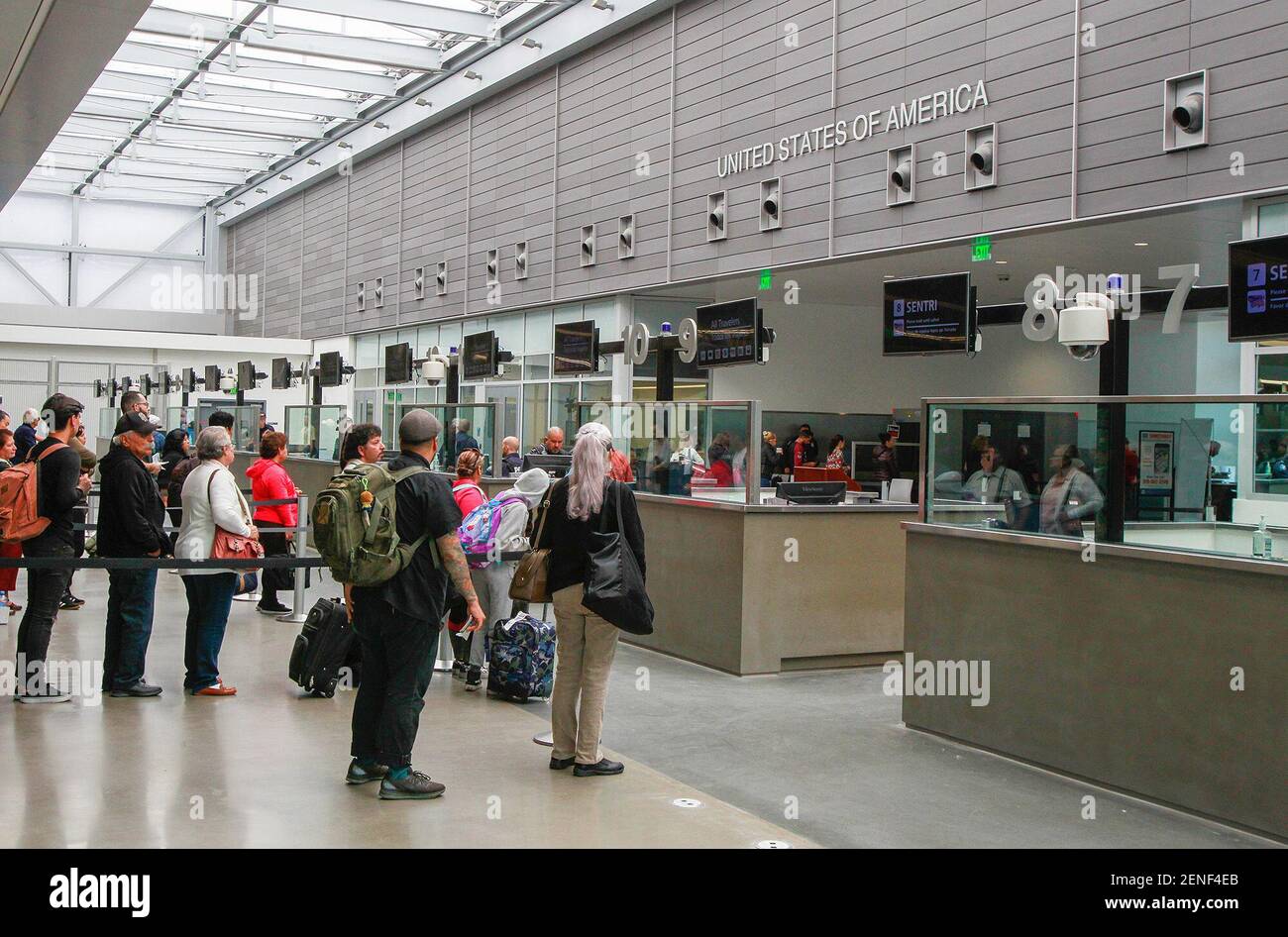 Pedestrians wait in line to present documents to U.S. Customs and ...