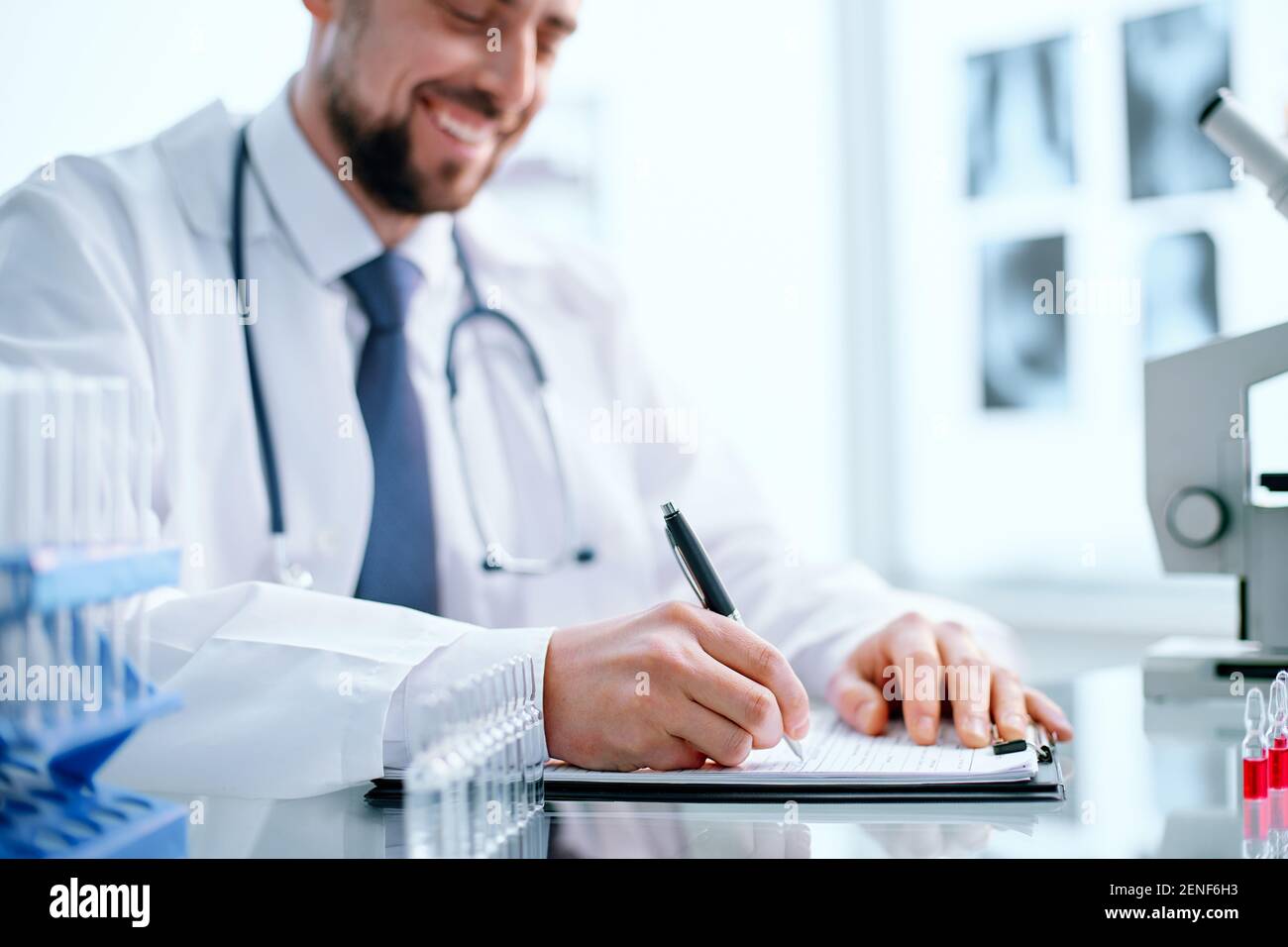 researcher writes down the results of research in a laboratory journal ...
