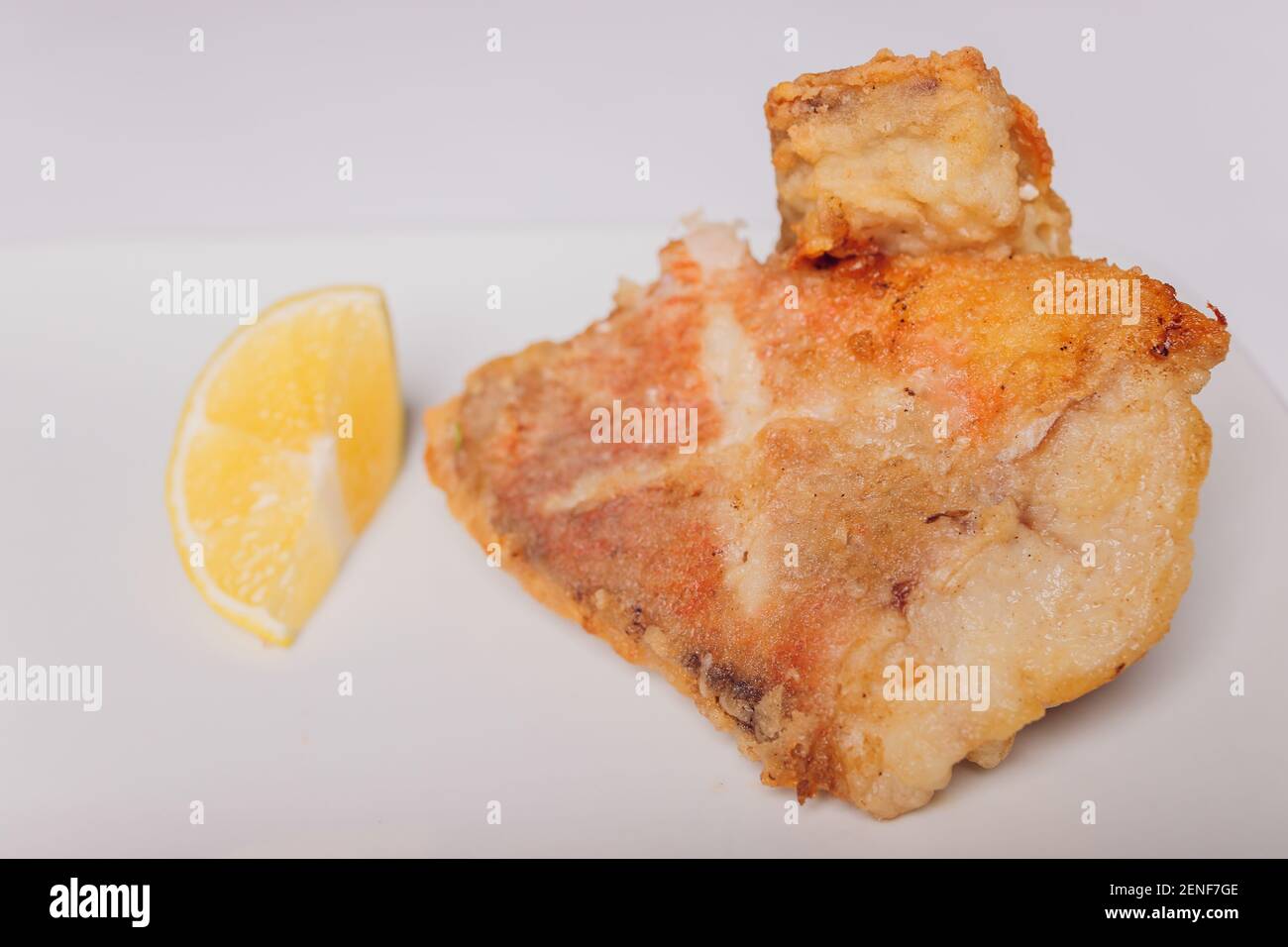 Battered fish fillet isolated over white background Stock Photo - Alamy