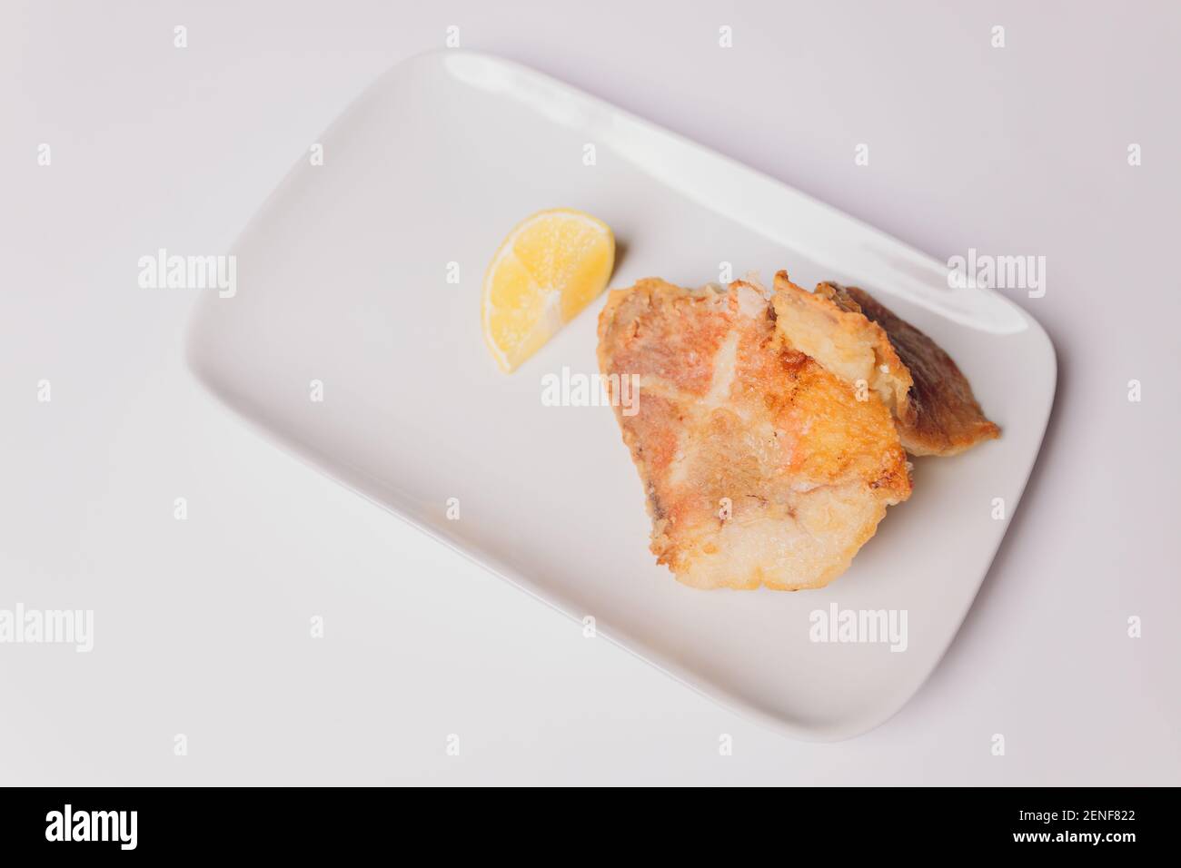 Battered fish fillet isolated over white background Stock Photo - Alamy