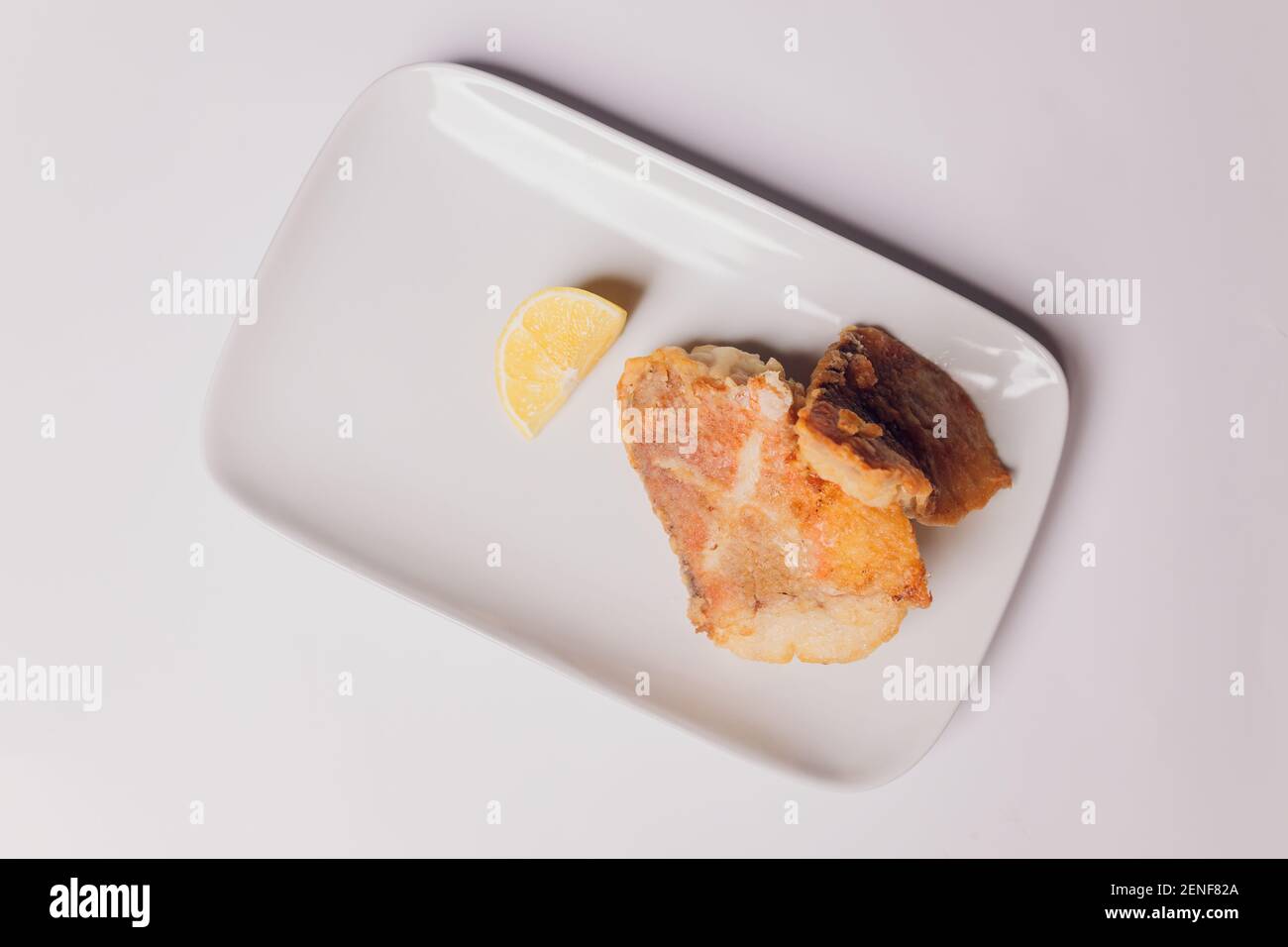 Battered fish fillet isolated over white background Stock Photo - Alamy