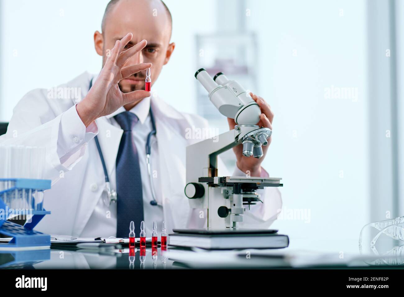scientist studying vaccine samples through a microscope Stock Photo - Alamy