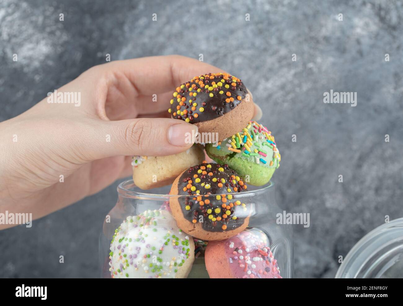 Close up photo of Female hand taking cookie from jar Stock Photo - Alamy