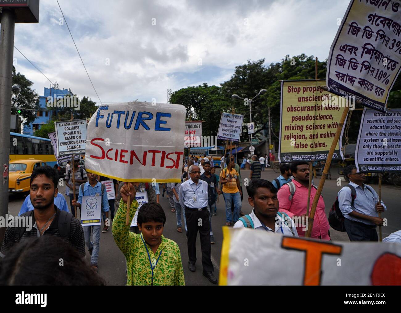 Scientist and students of different colleges hold placards during the ...