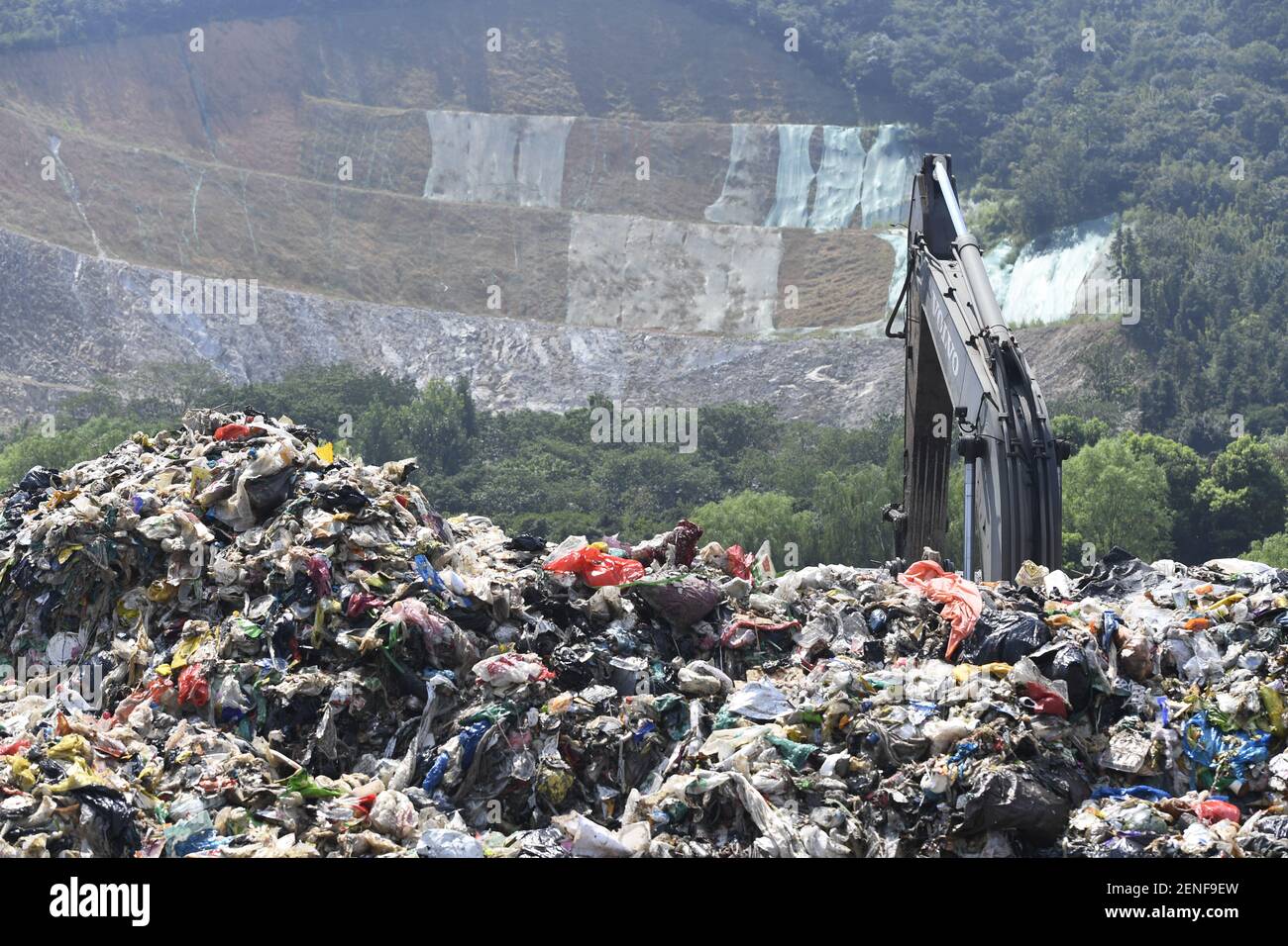 Chinese workers sort out and bury kitchen waste at the Tianziling ...