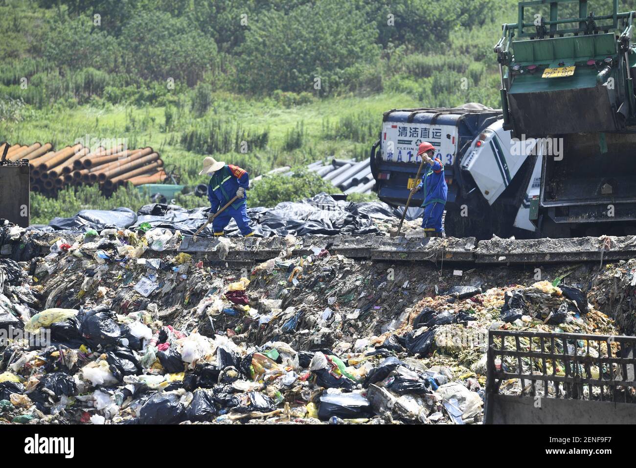 Chinese workers sort out and bury kitchen waste at the Tianziling ...