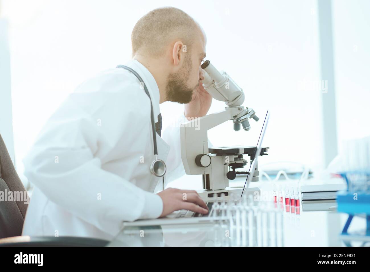 scientist examining blood samples in a lab. side view Stock Photo - Alamy